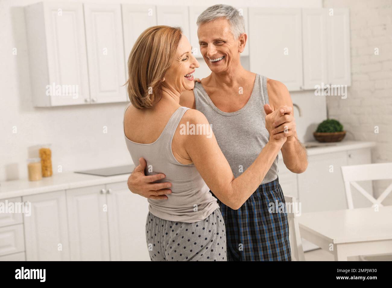 Excited couple dancing together in hi-res stock photography and images ...