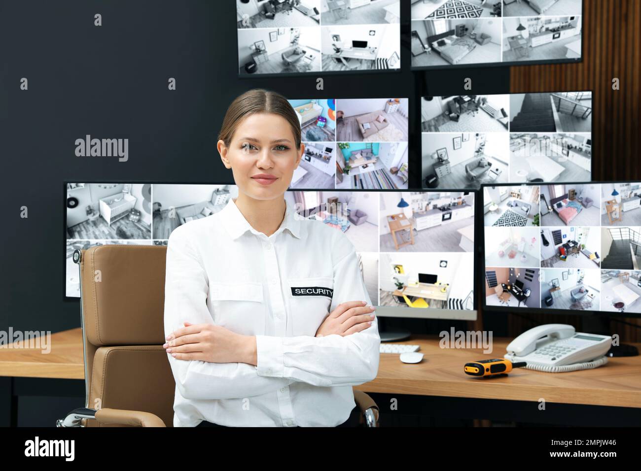 Security guard in uniform at workplace with monitors Stock Photo - Alamy