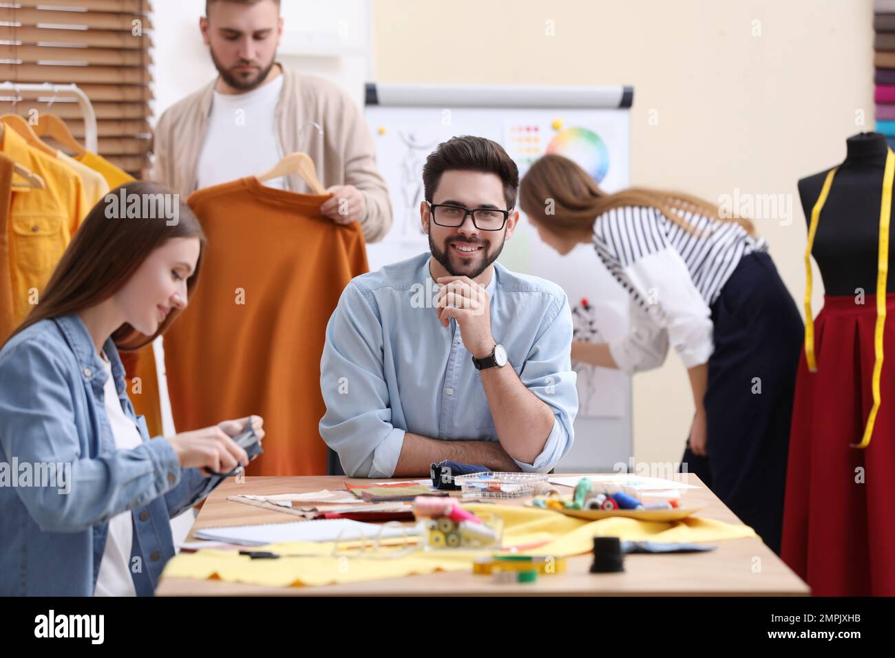 Fashion designers creating new clothes in studio Stock Photo - Alamy