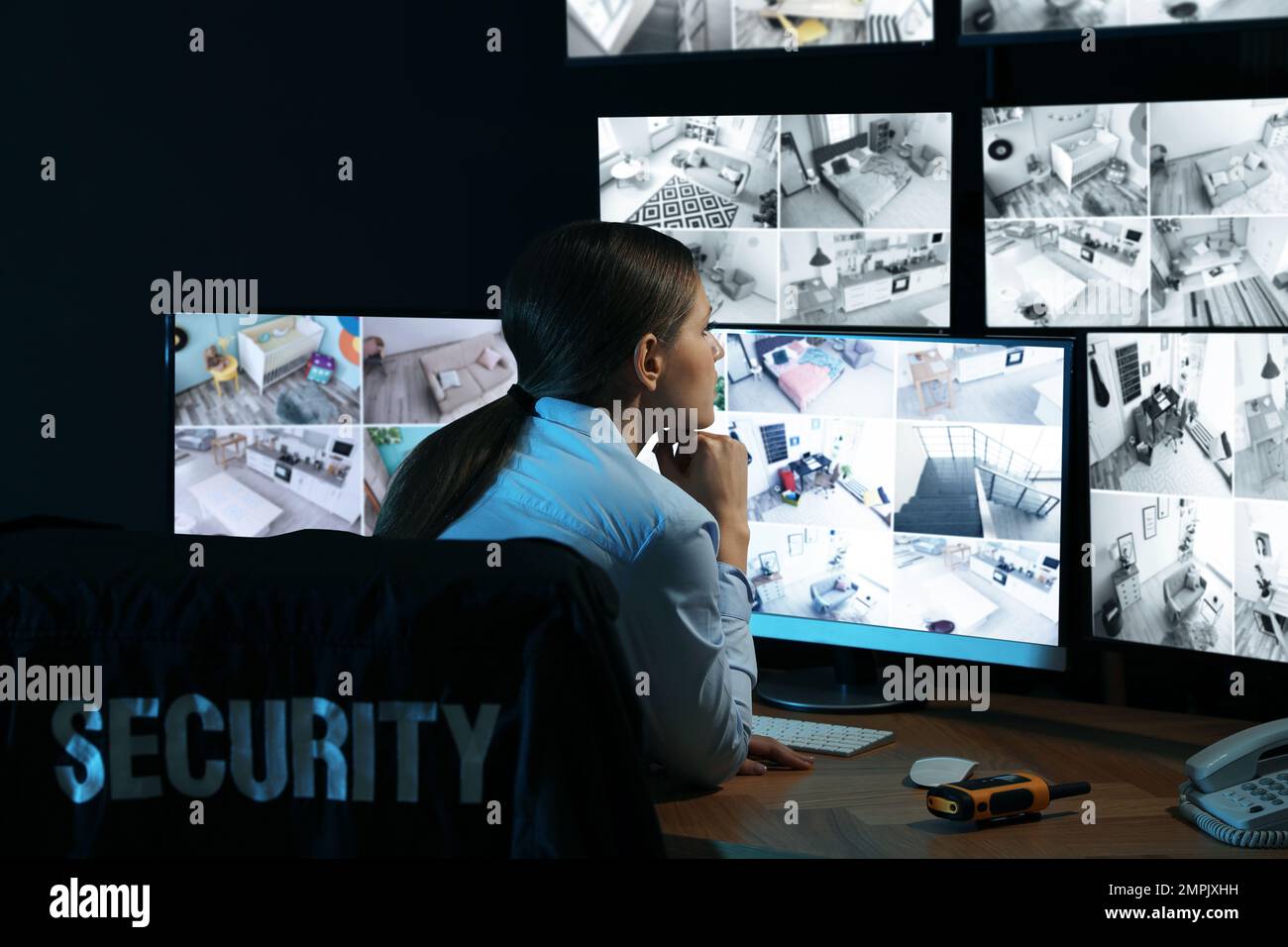 Security guard monitoring modern CCTV cameras indoors at night Stock ...
