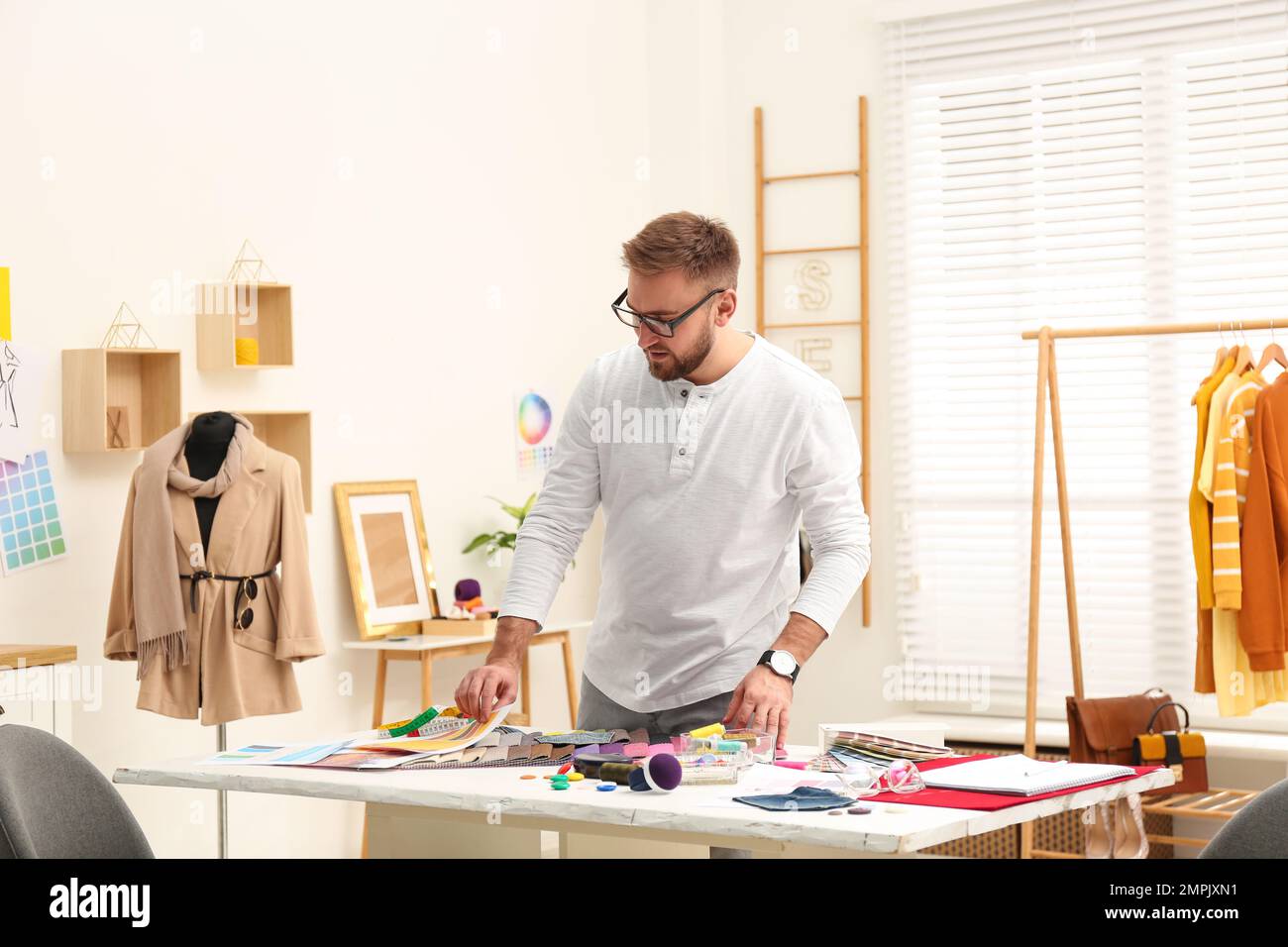 Fashion designer creating new clothes in studio Stock Photo - Alamy