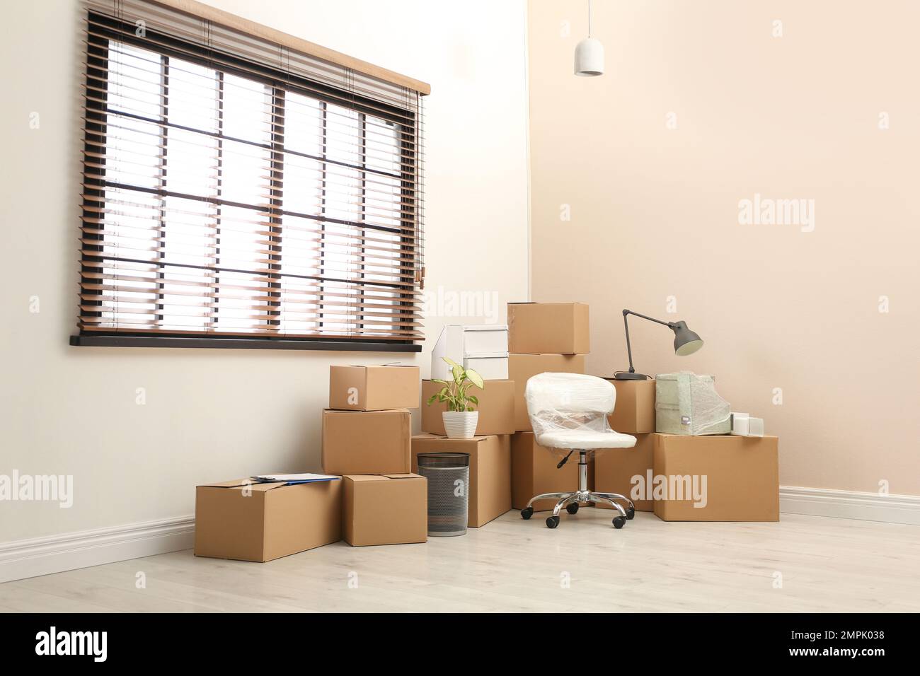 Moving boxes and stuff near window in room Stock Photo - Alamy