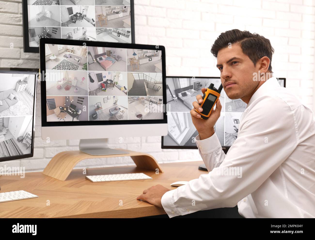 Male security guard with portable transmitter at workplace Stock Photo ...