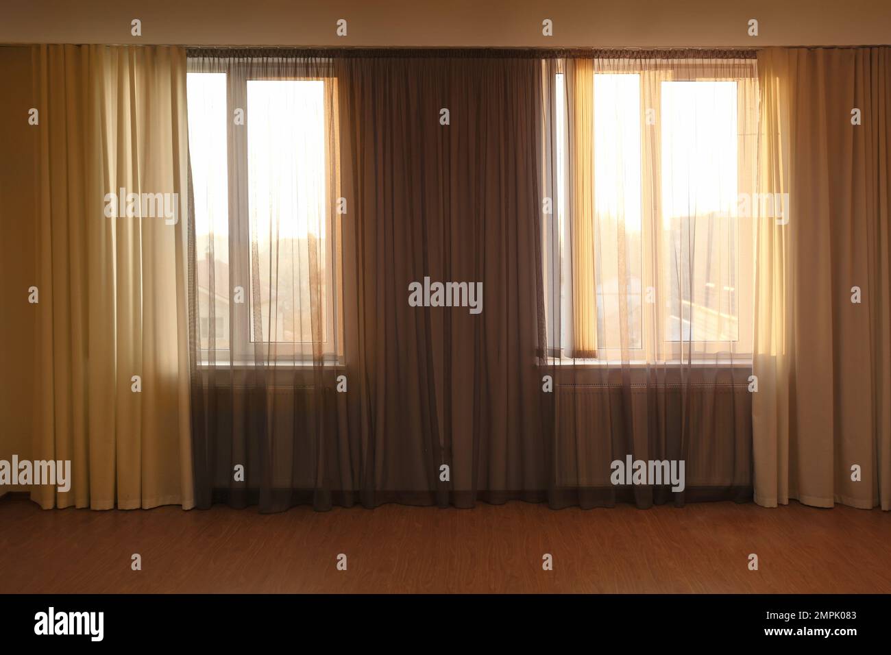 Windows with beautiful curtains in empty room Stock Photo - Alamy