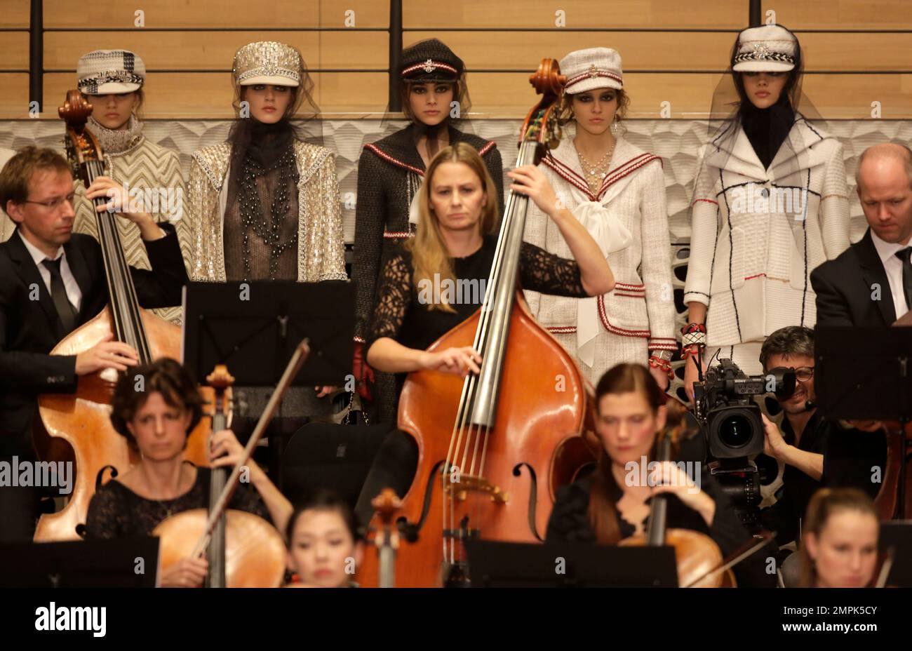Models present creations when standing behind an orchestra at Chanel's ...