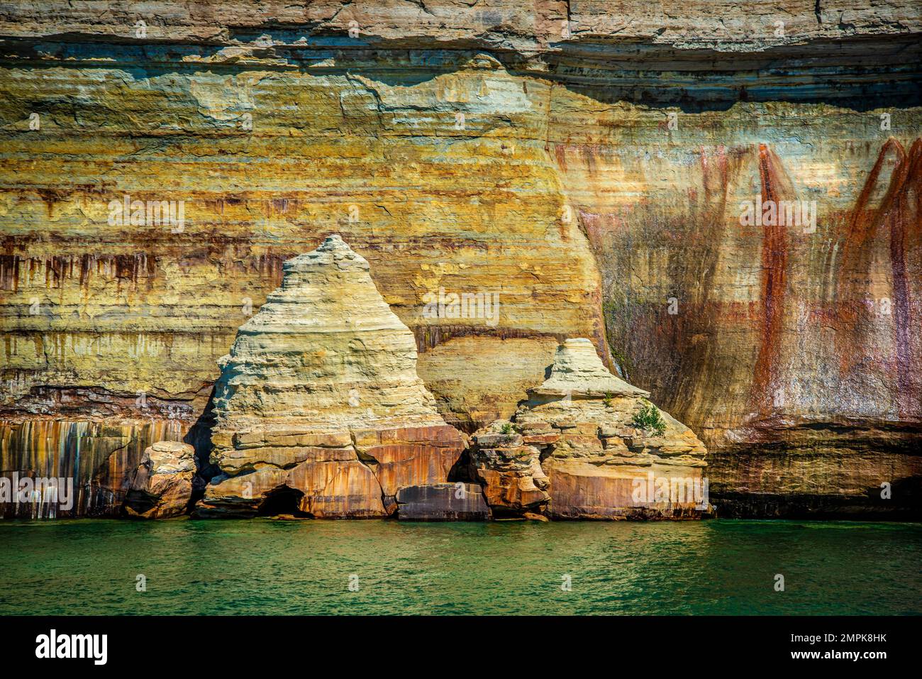 Fallen granite stone with mineral stained walls Stock Photo - Alamy