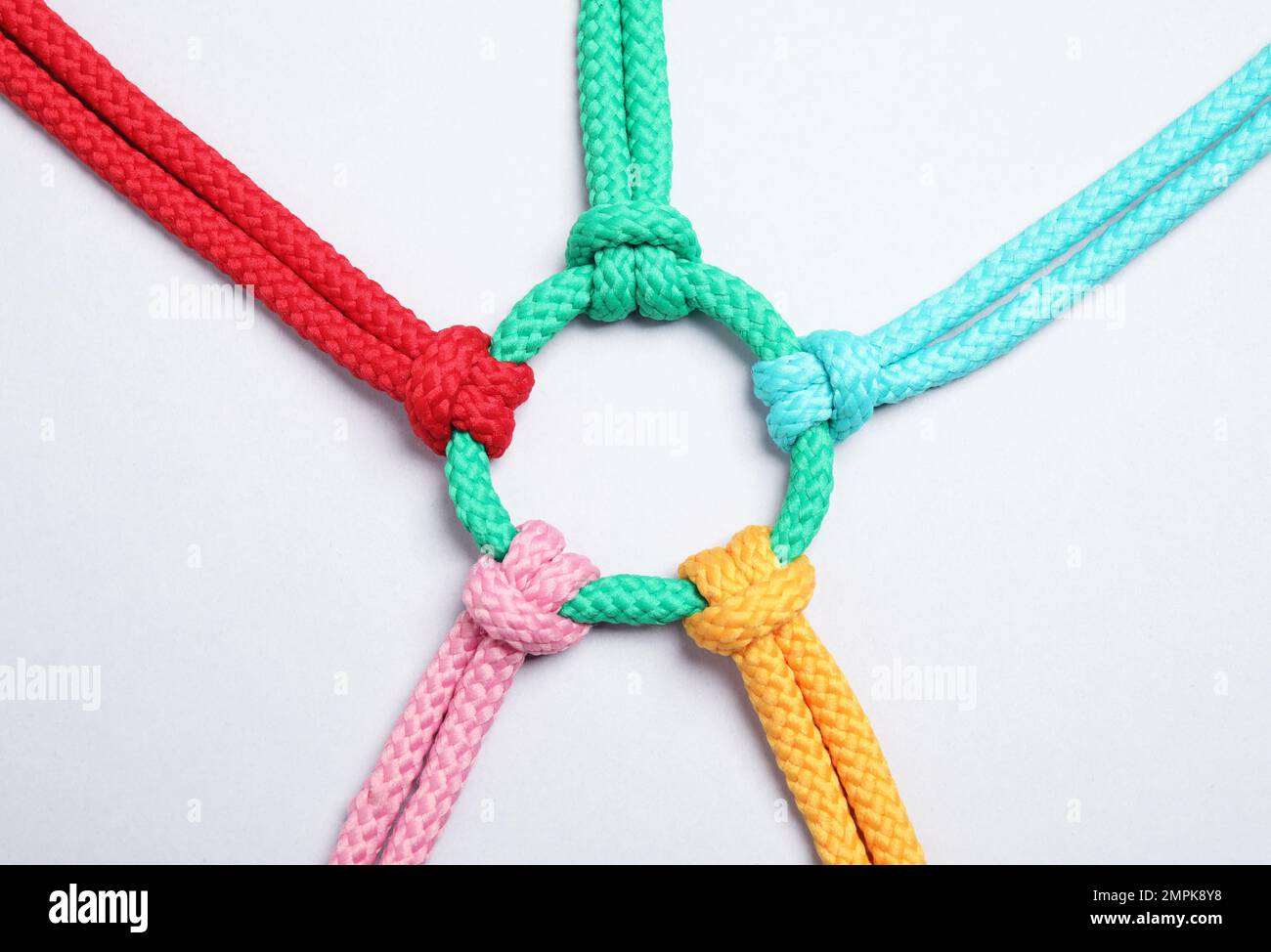 Colorful ropes tied together on white background, top view. Unity ...