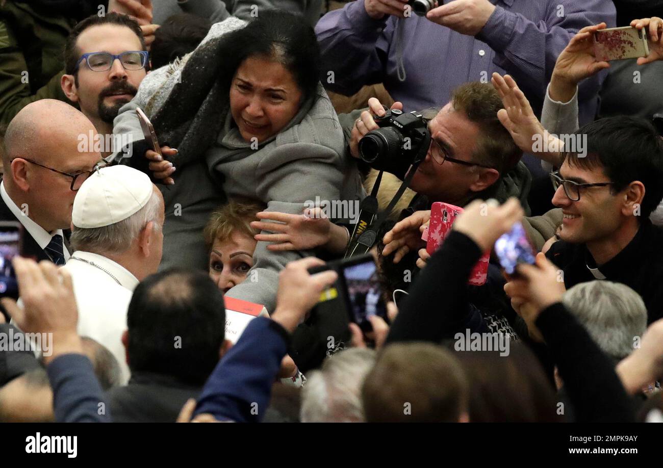 Pope Francis waves to the crowd as he arrives for his weekly general ...