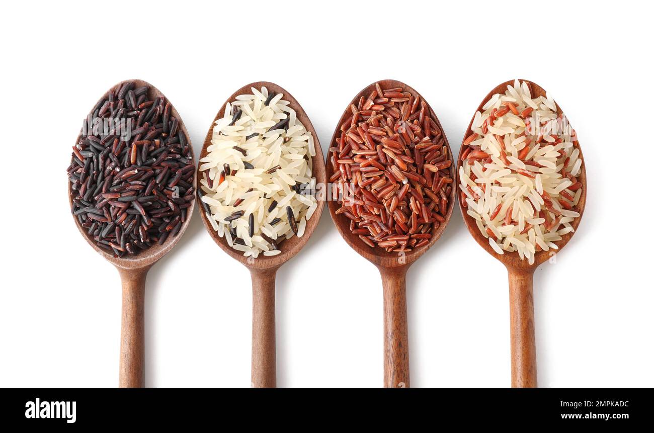 Brown and mixed rice in spoons isolated on white, top view Stock Photo ...