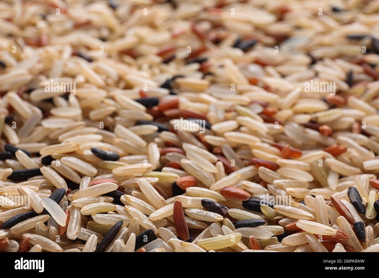 Mix of different brown rice as background, closeup Stock Photo - Alamy