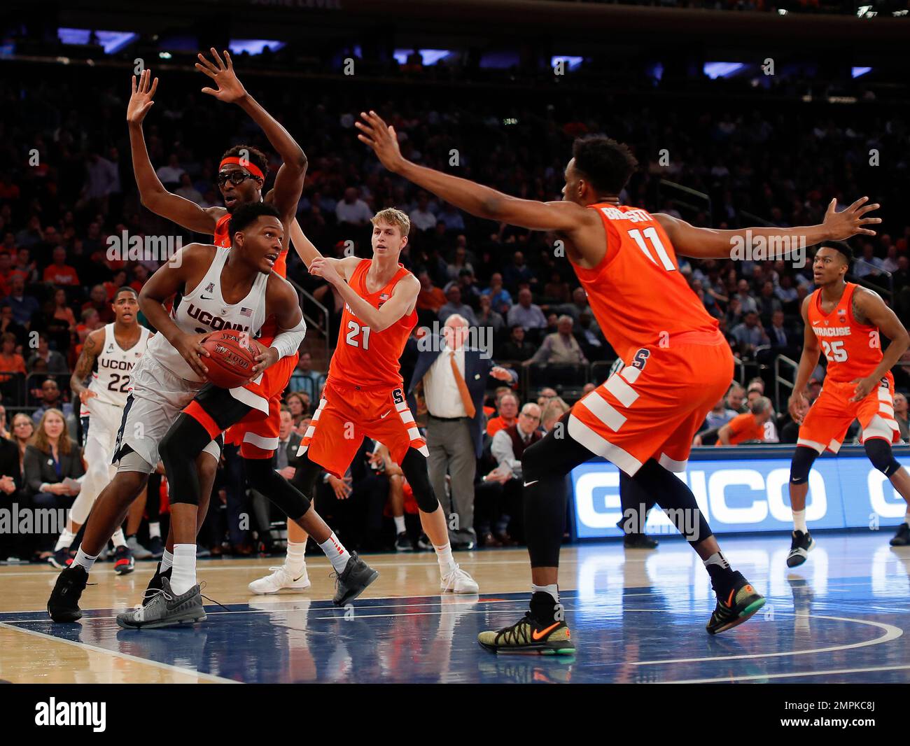 Connecticut forward Josh Carlton (25) drives around Syracuse center ...