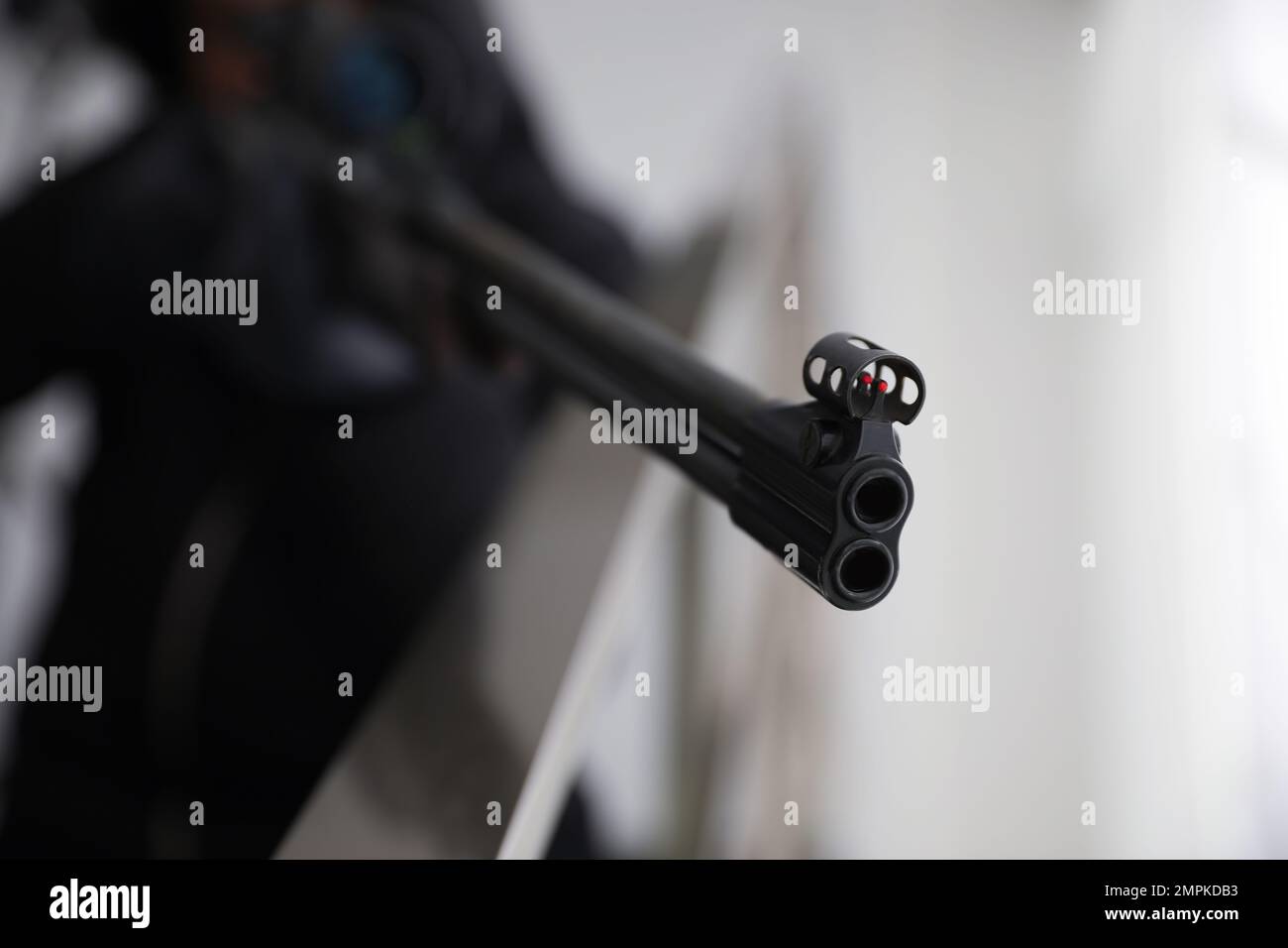 Hired professional killer indoors, focus on sniper rifle Stock Photo ...