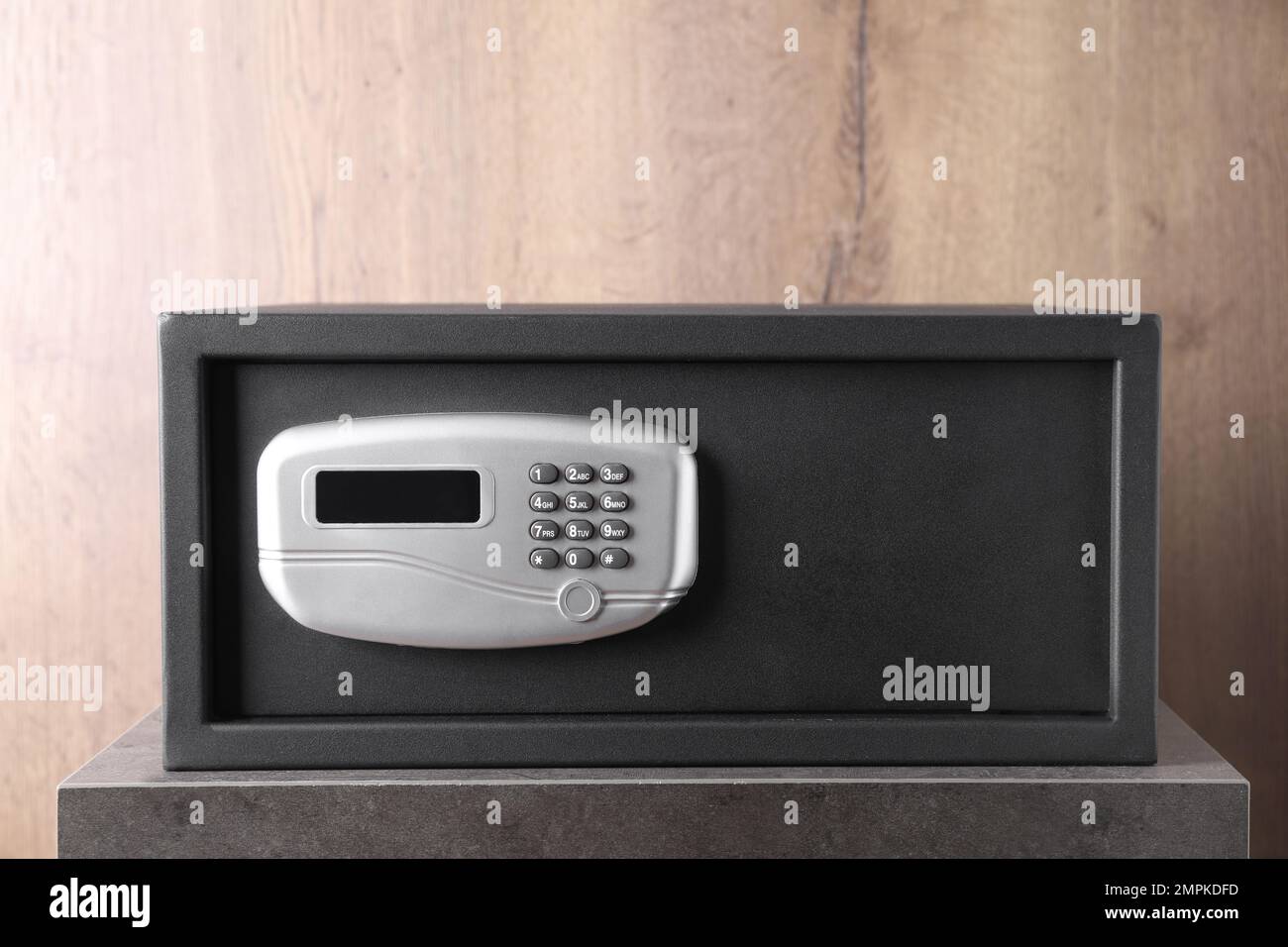 Black steel safe with electronic lock on grey table Stock Photo - Alamy