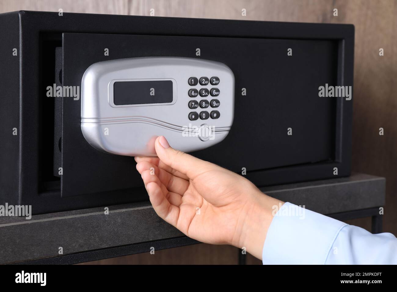 Woman opening black steel safe with electronic lock, closeup Stock ...