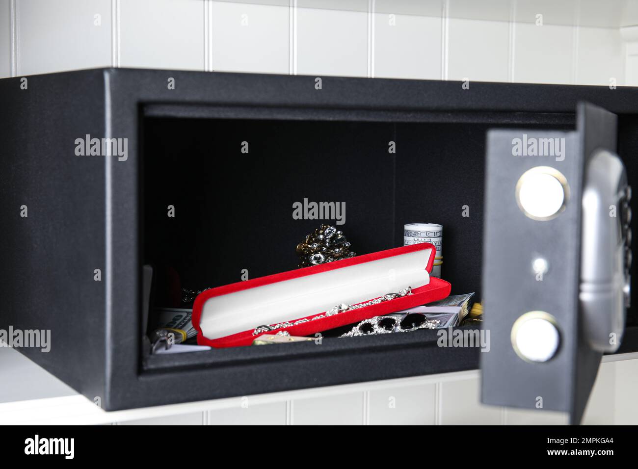 Open black steel safe with money and jewelry on shelf Stock Photo - Alamy