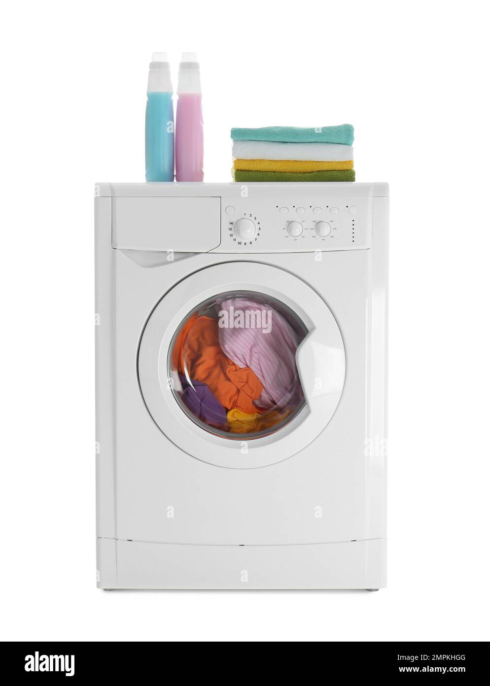 Modern washing machine with laundry, stack of towels and detergents on ...