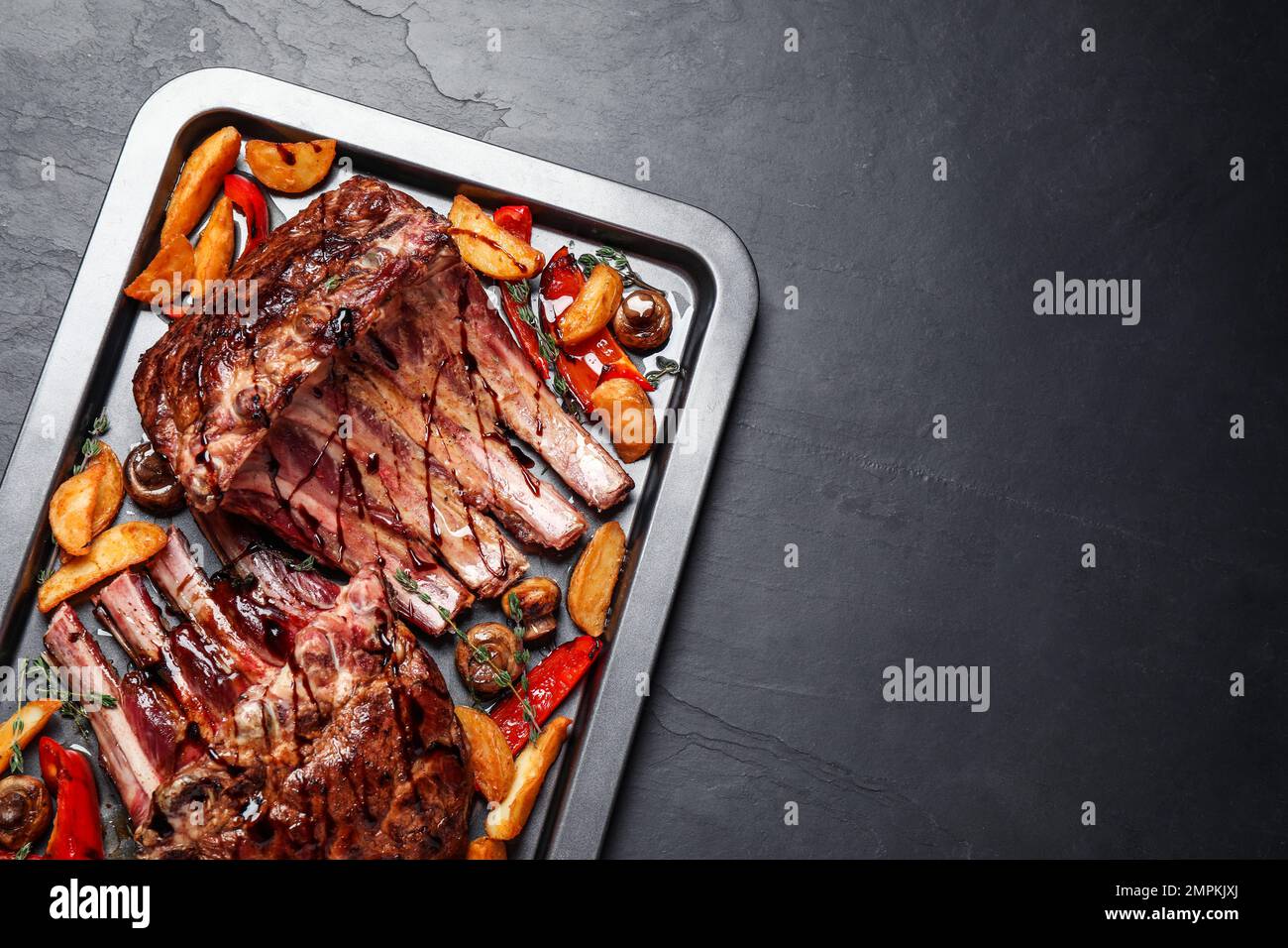 Delicious roasted ribs with garnish, top view. Space for text Stock ...