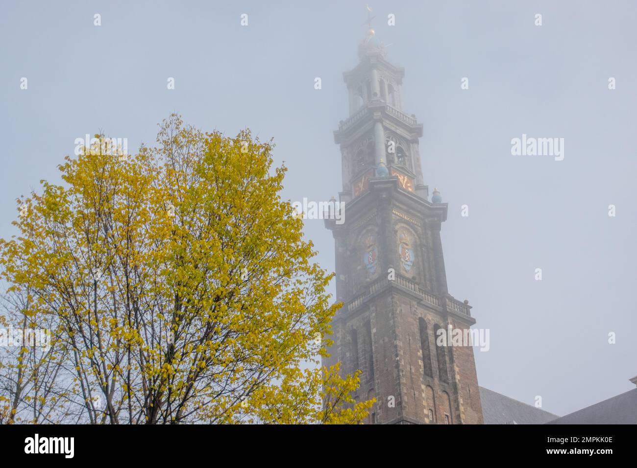 Looking up at the spire of Westerkerk on the banks of Prinsengracht ...
