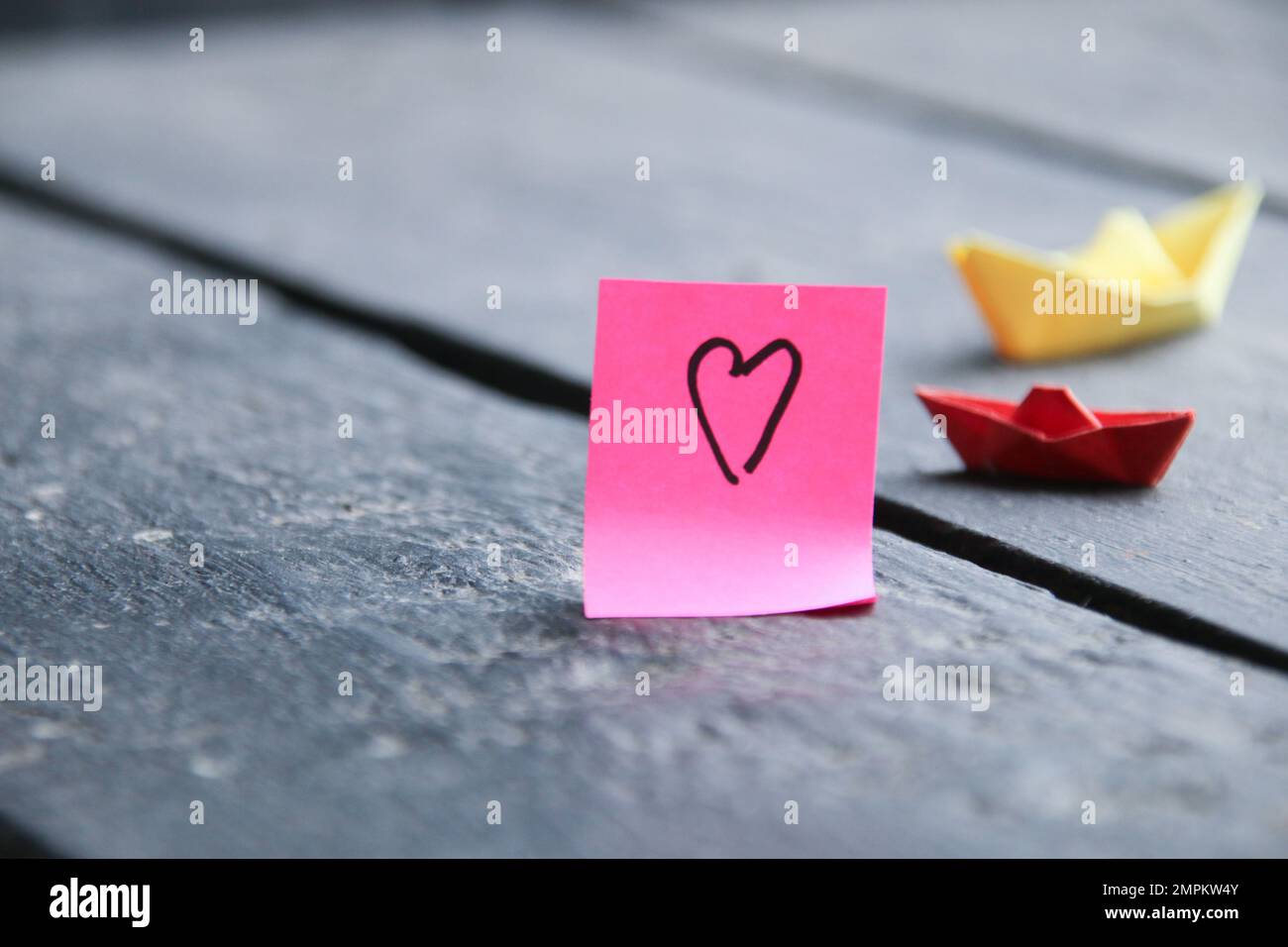 Love heart. Drawing on the tag and two paper boats Stock Photo - Alamy