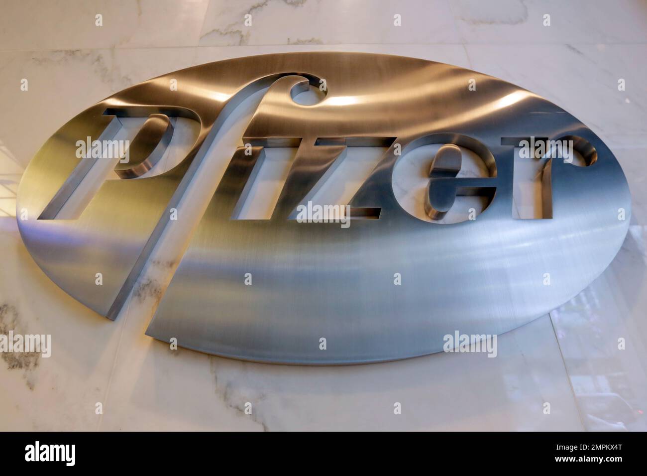 The Pfizer company logo is photographed at Pfizer Inc. headquarters, in ...
