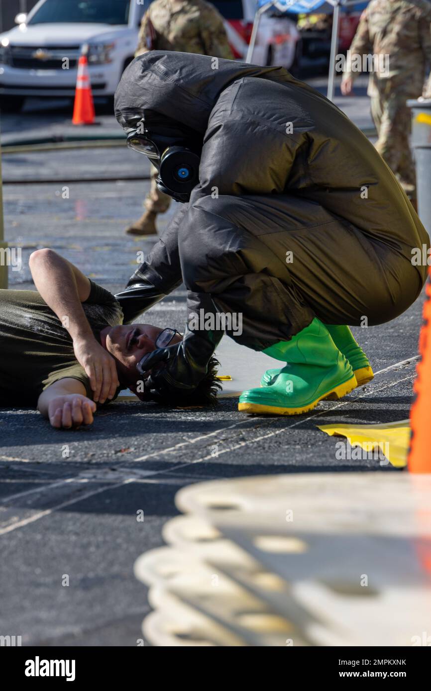 A U.S. Marine with Chemical Biological Incident Response Force treats a ...