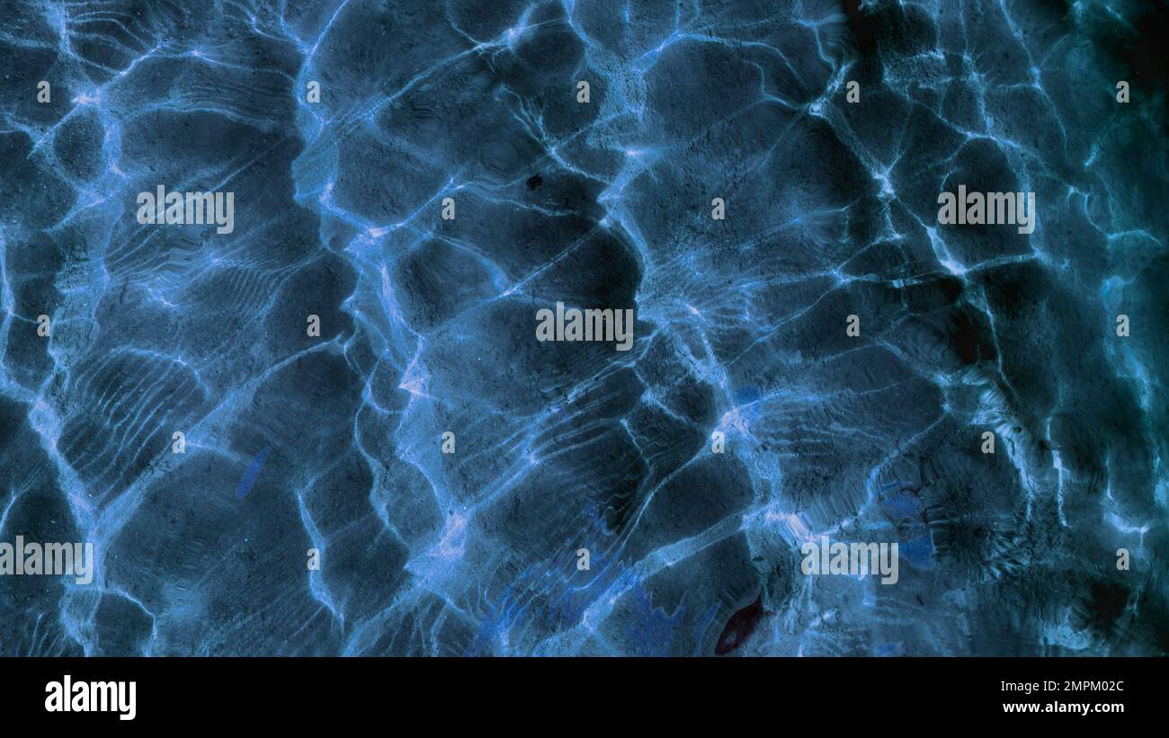 Abstract photo of the glow of the surface of transparent water with the ...