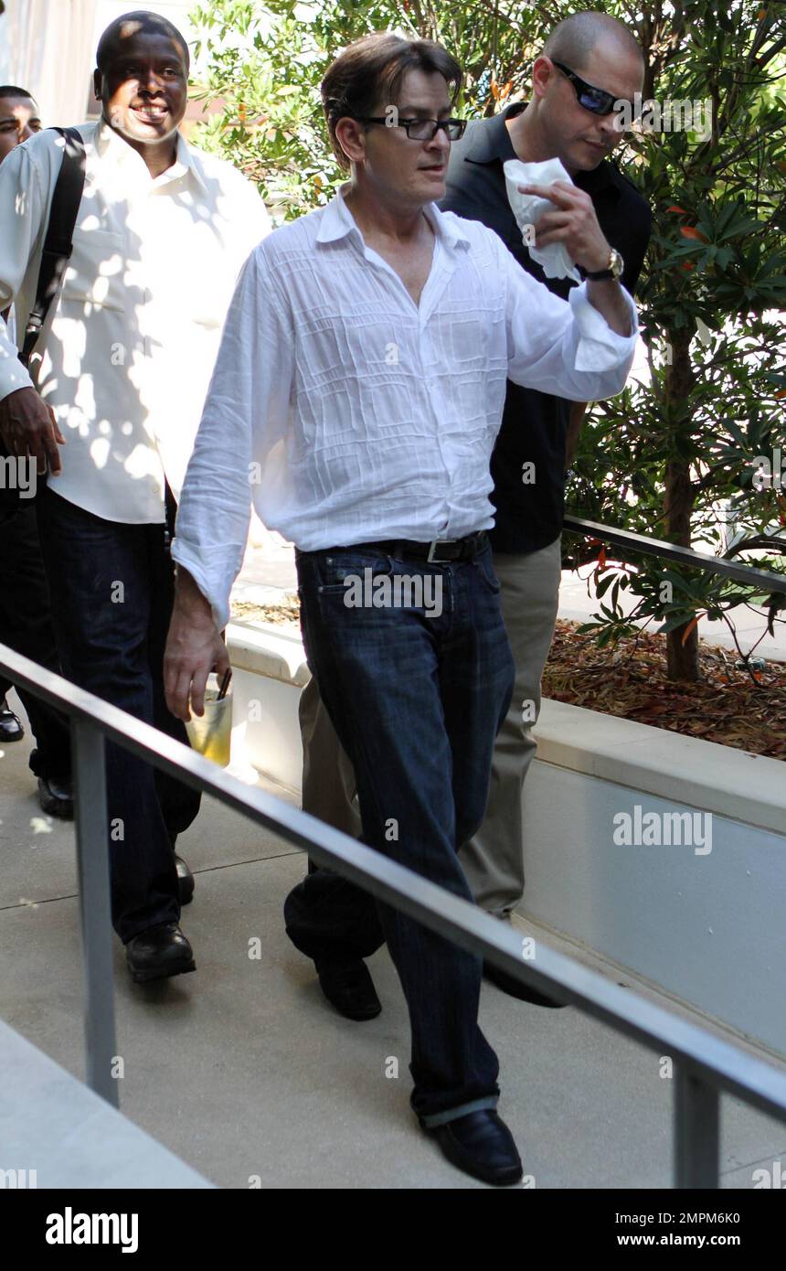 Charlie Sheen relaxes and smokes a cigarette while on the set of Access ...