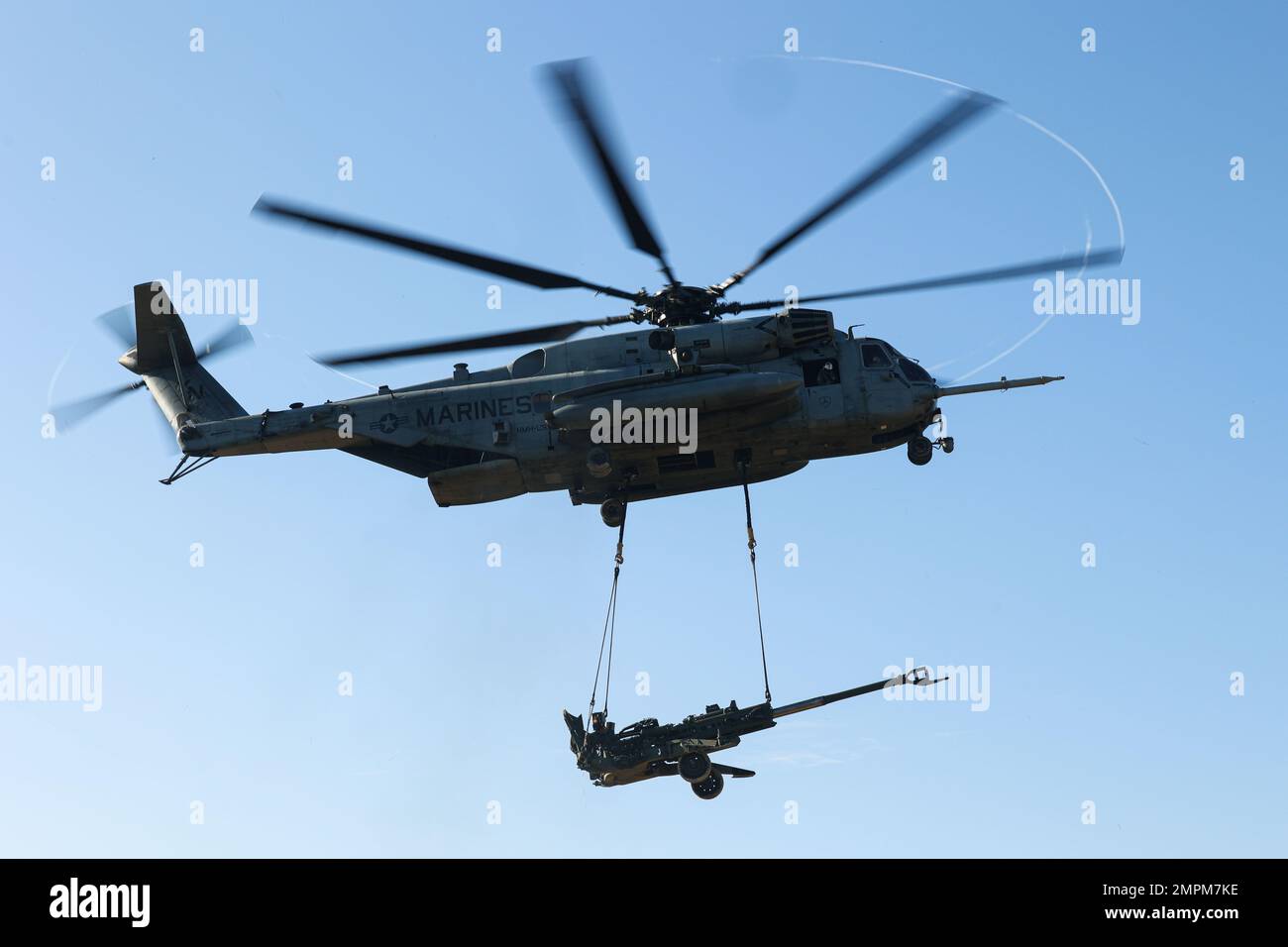 A U.S. Marine Corps CH-53E Super Stallion lifts an M777 Howitzer during ...