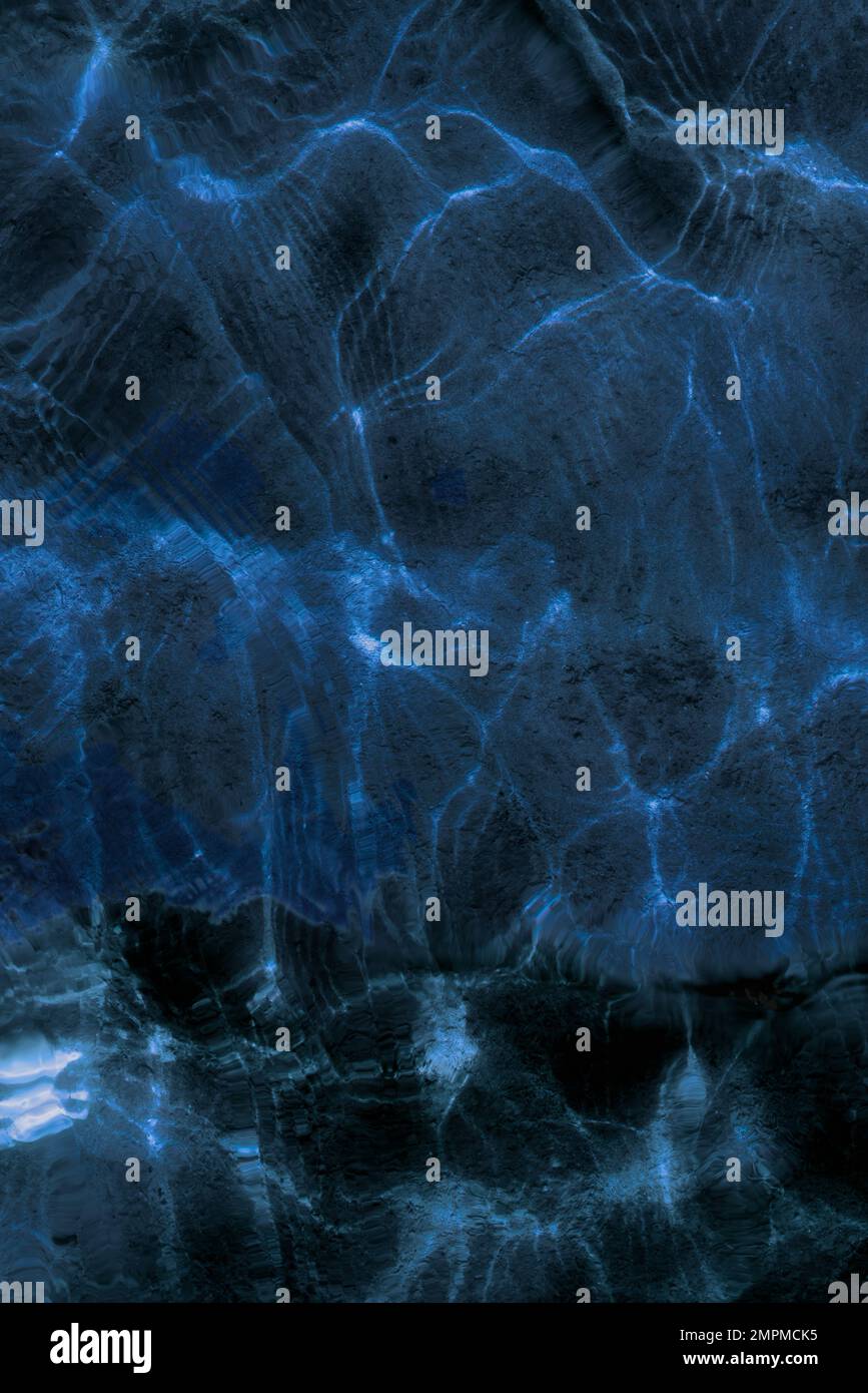 Abstract photo of the glow of the surface of transparent water with the ...