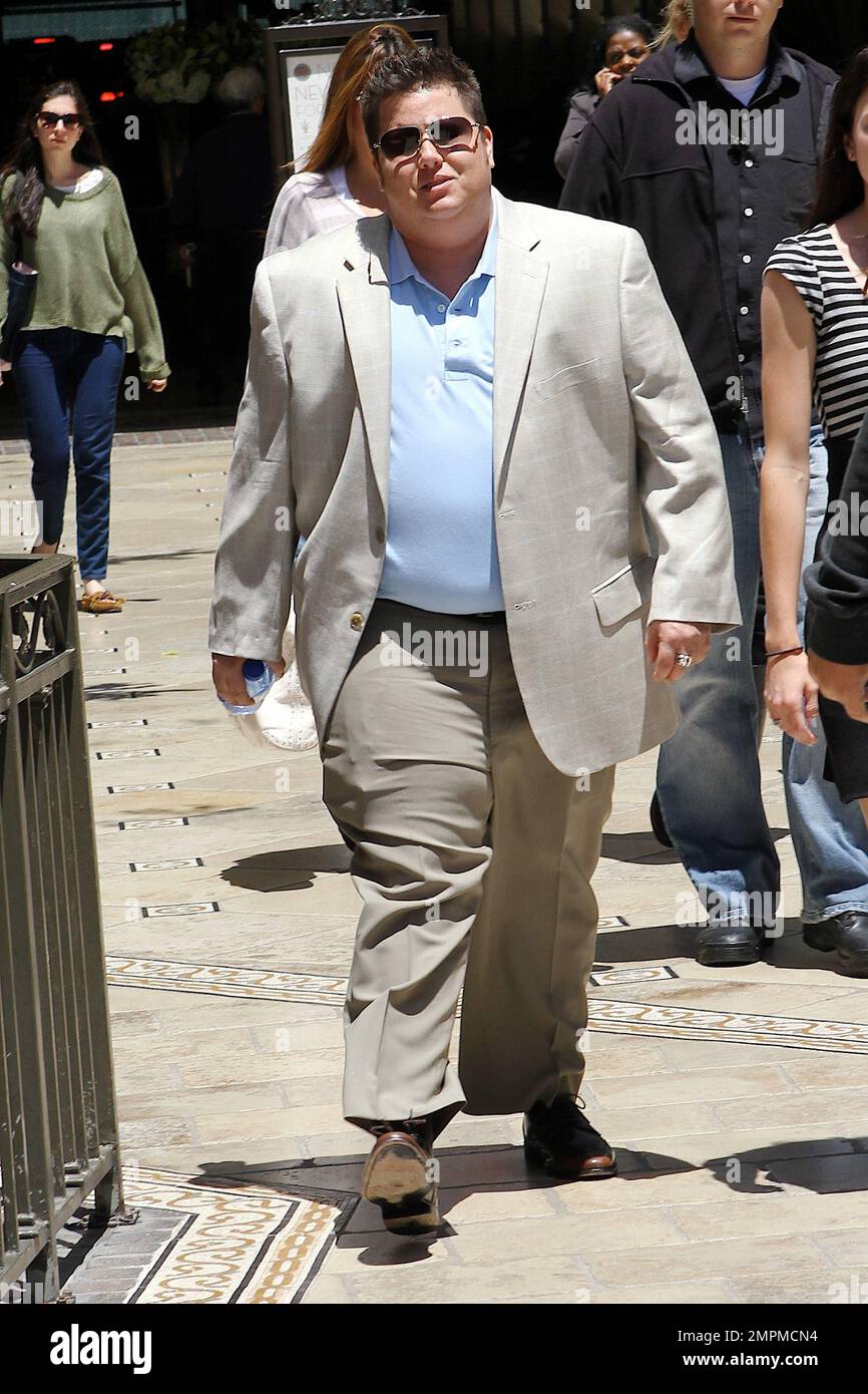 Chaz Bono wears a tan suit and blue shirt while out at The Grove. Los ...
