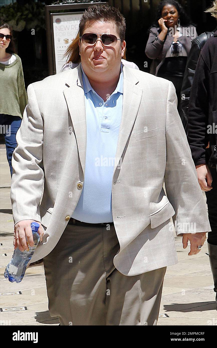 Chaz Bono wears a tan suit and blue shirt while out at The Grove. Los ...