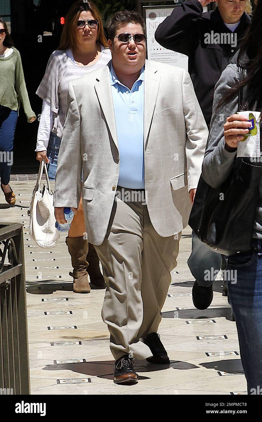 Chaz Bono wears a tan suit and blue shirt while out at The Grove. Los ...