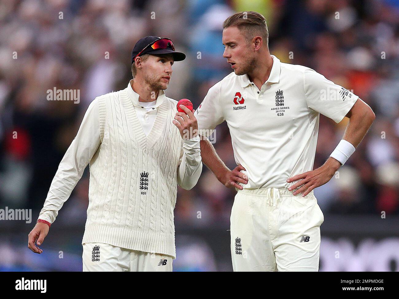 England's Joe Root, left, talks with his bowler Stuart Broad during the ...