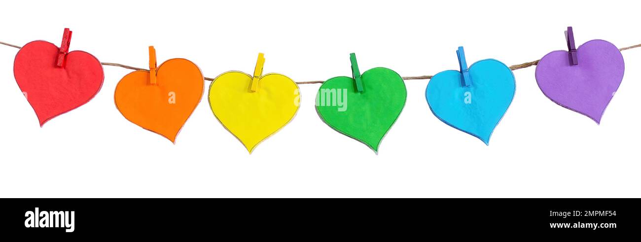 The rainbow-colored paper hearts hanging from a rope on the empty white ...