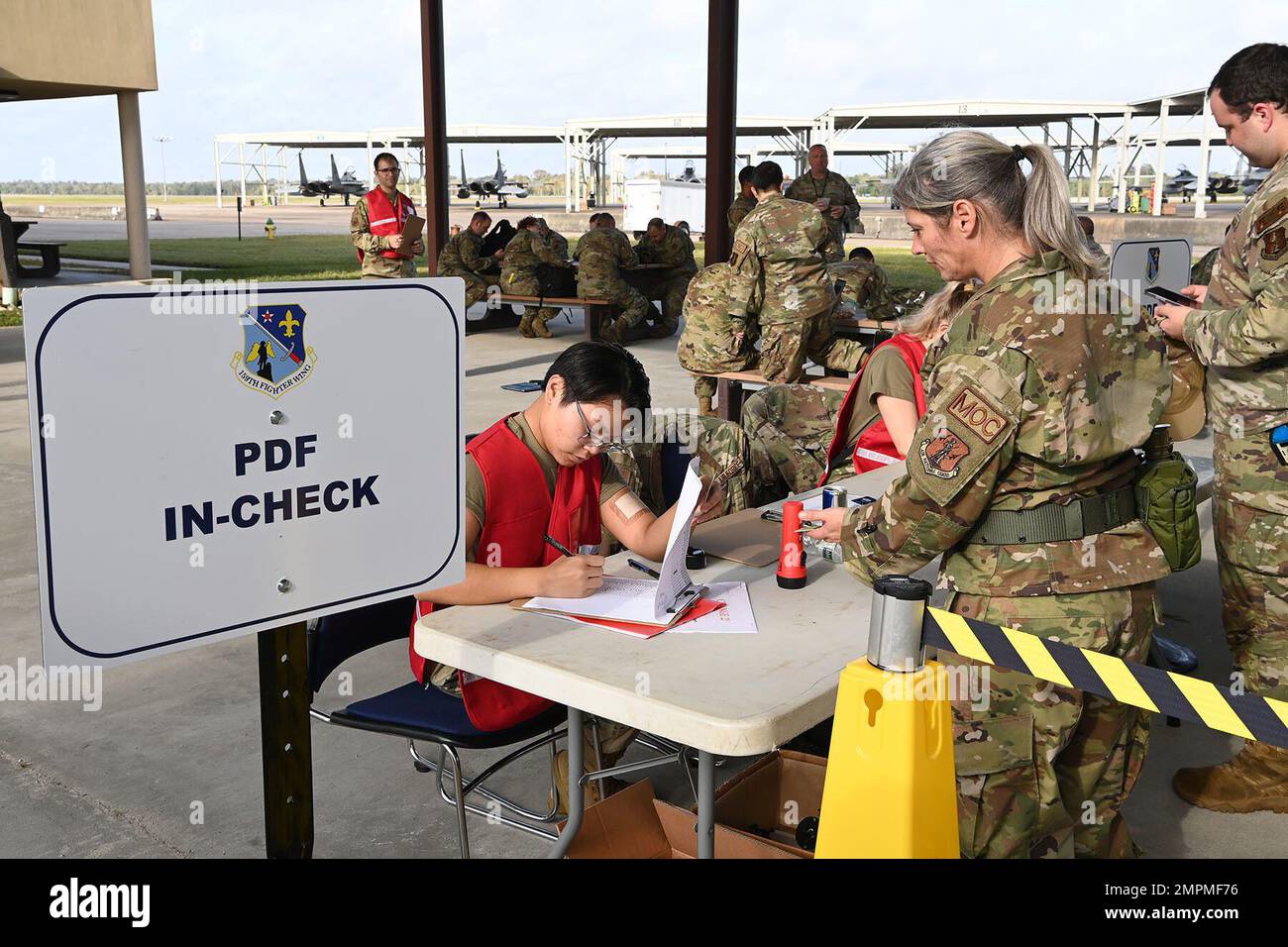 A 159th Fighter Wing Airman processes another Airman into a personnel ...