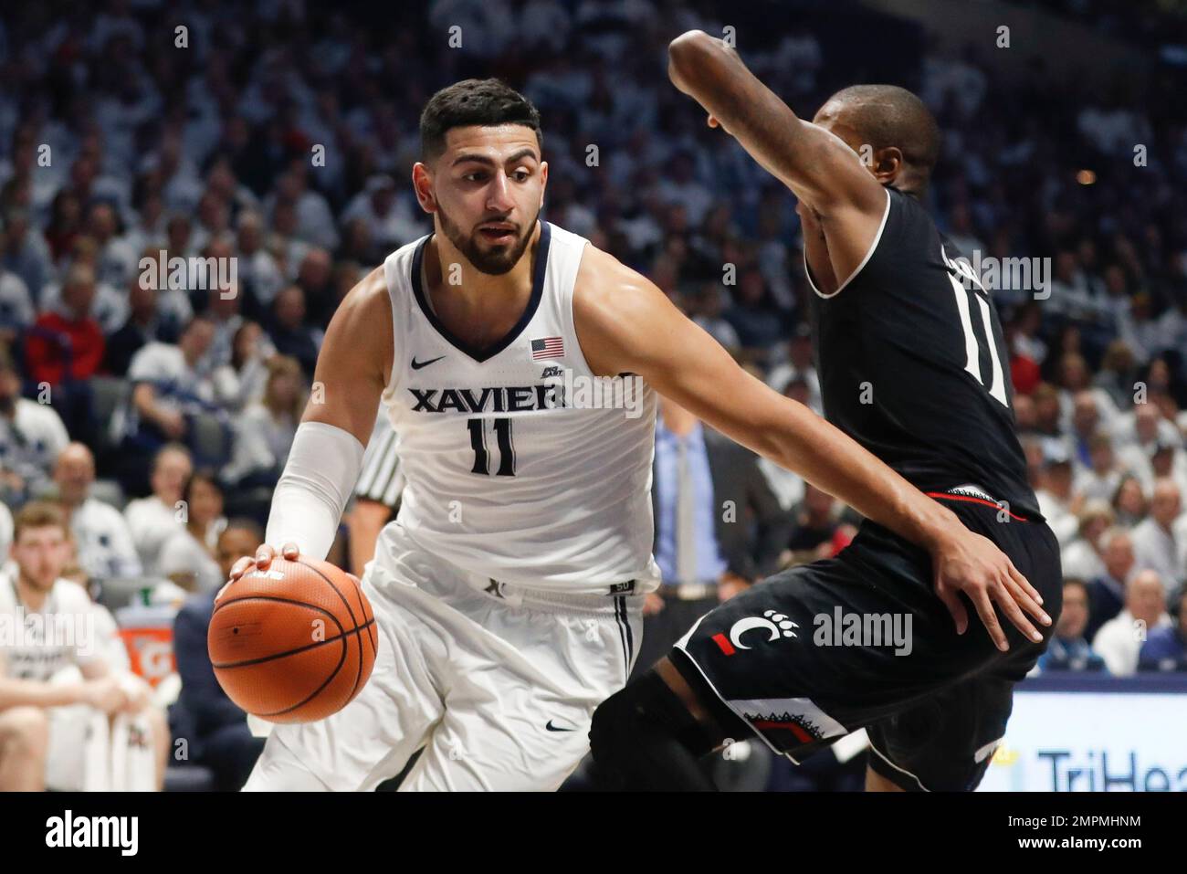 Xavier's Kerem Kanter (11) drives around Cincinnati's Gary Clark (11 ...