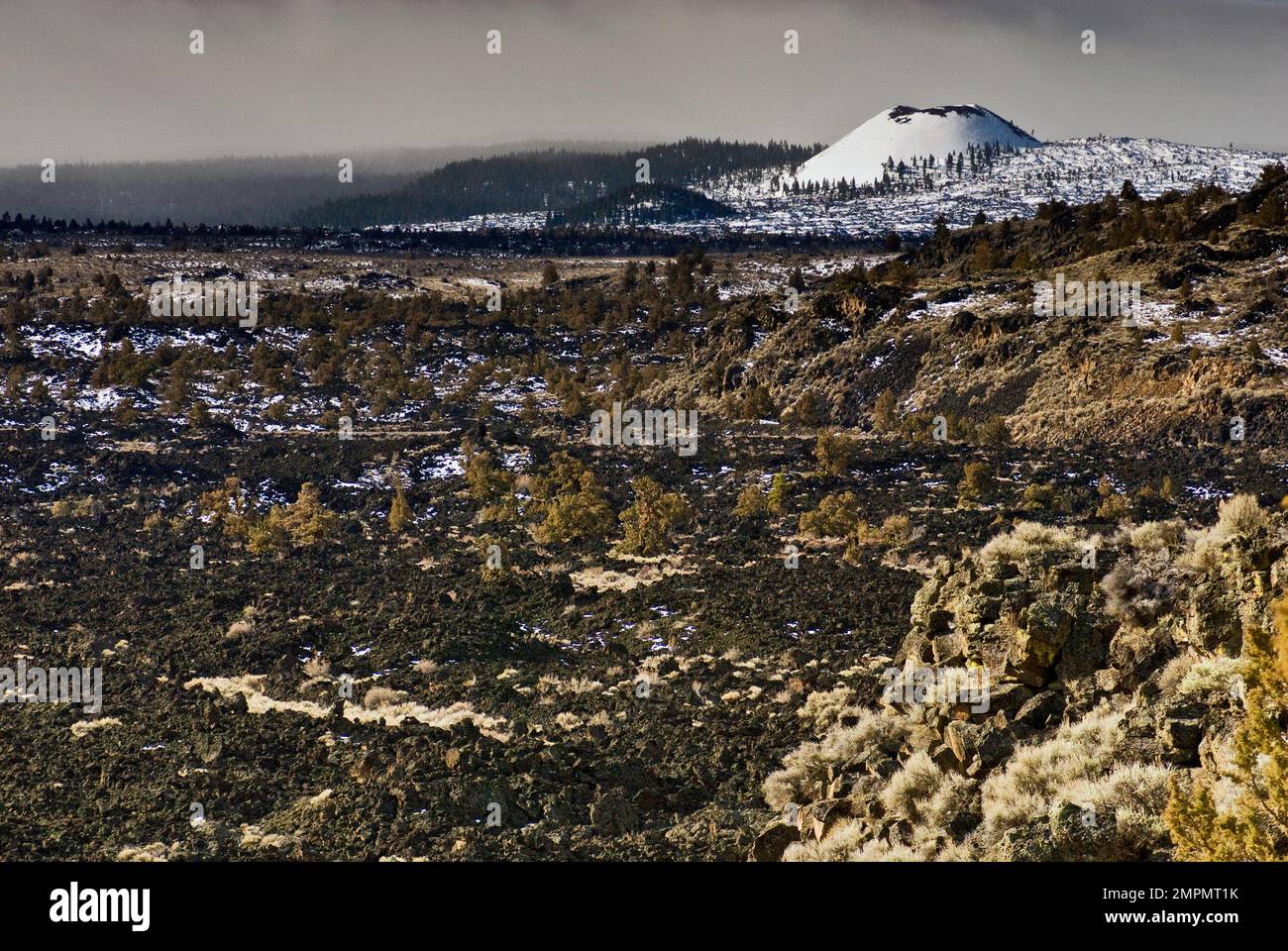 Devils Homestead Flow with Whitney Butte volcano covered with snow in ...