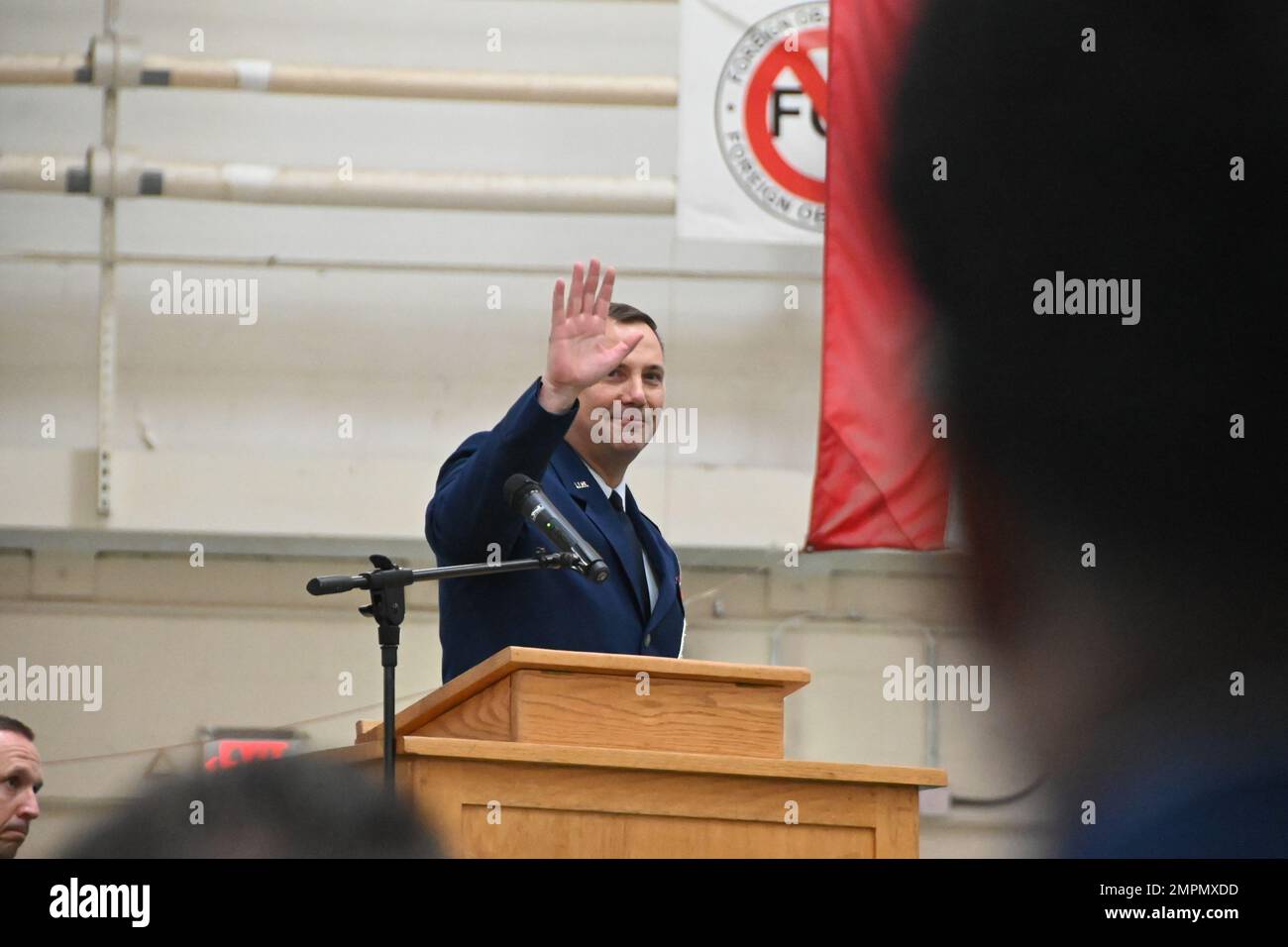Col. Todd Wiles, outgoing commander of the 118th Wing, waves the wing ...