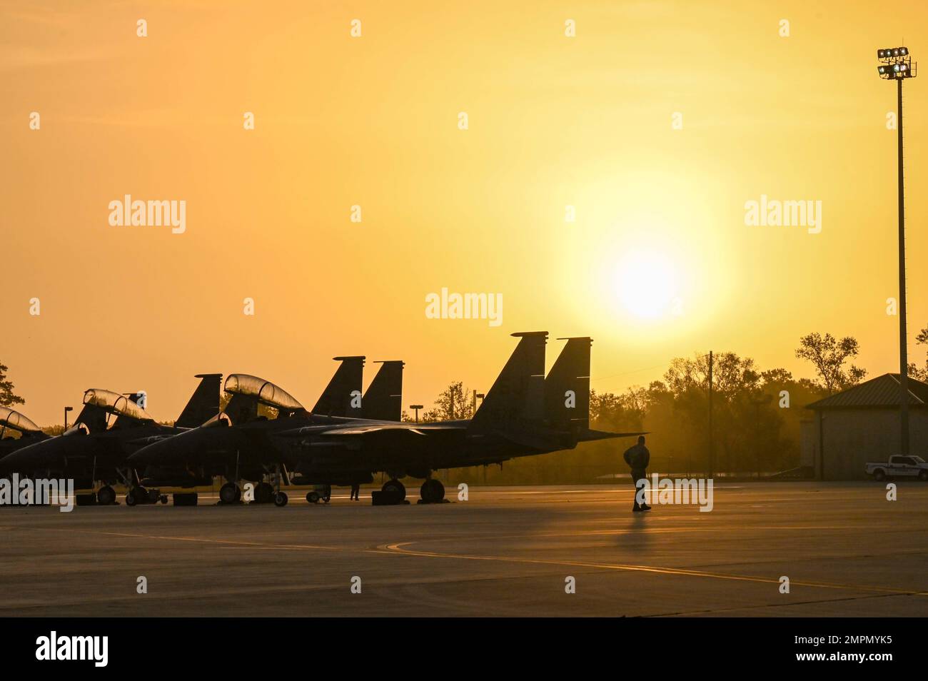 Multiple Airmen conduct a foreign object debris (FOD) walk prior to the ...