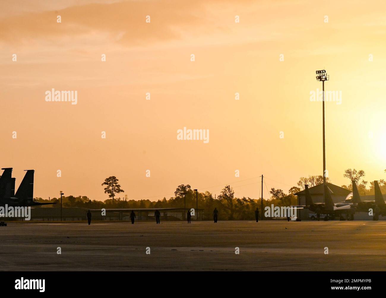 Multiple Airmen conduct a foreign object debris (FOD) walk prior to the ...