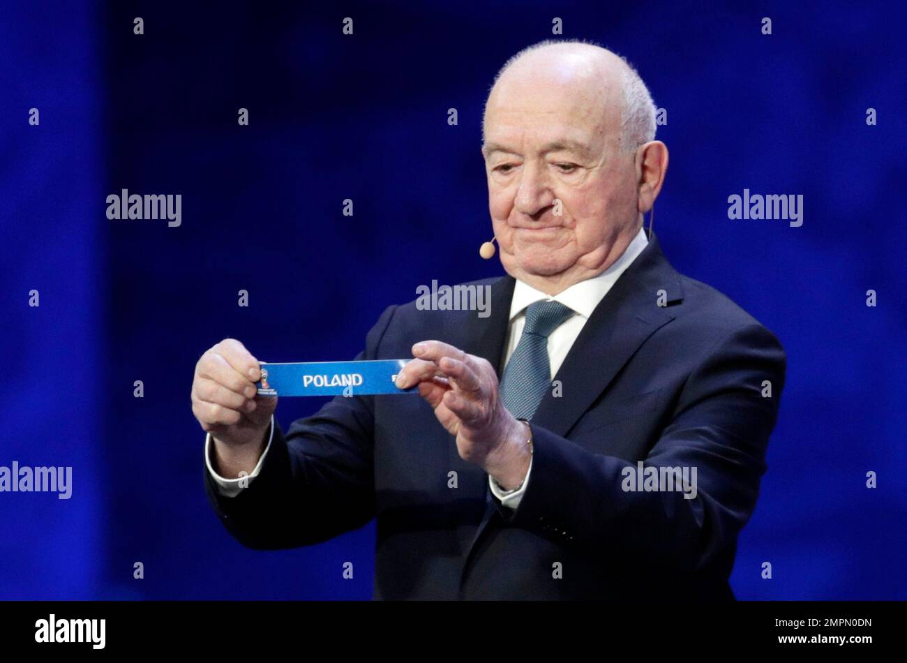 Former Russian soccer player Nikita Simonyan holds up the team name of Poland during the 2018 ...