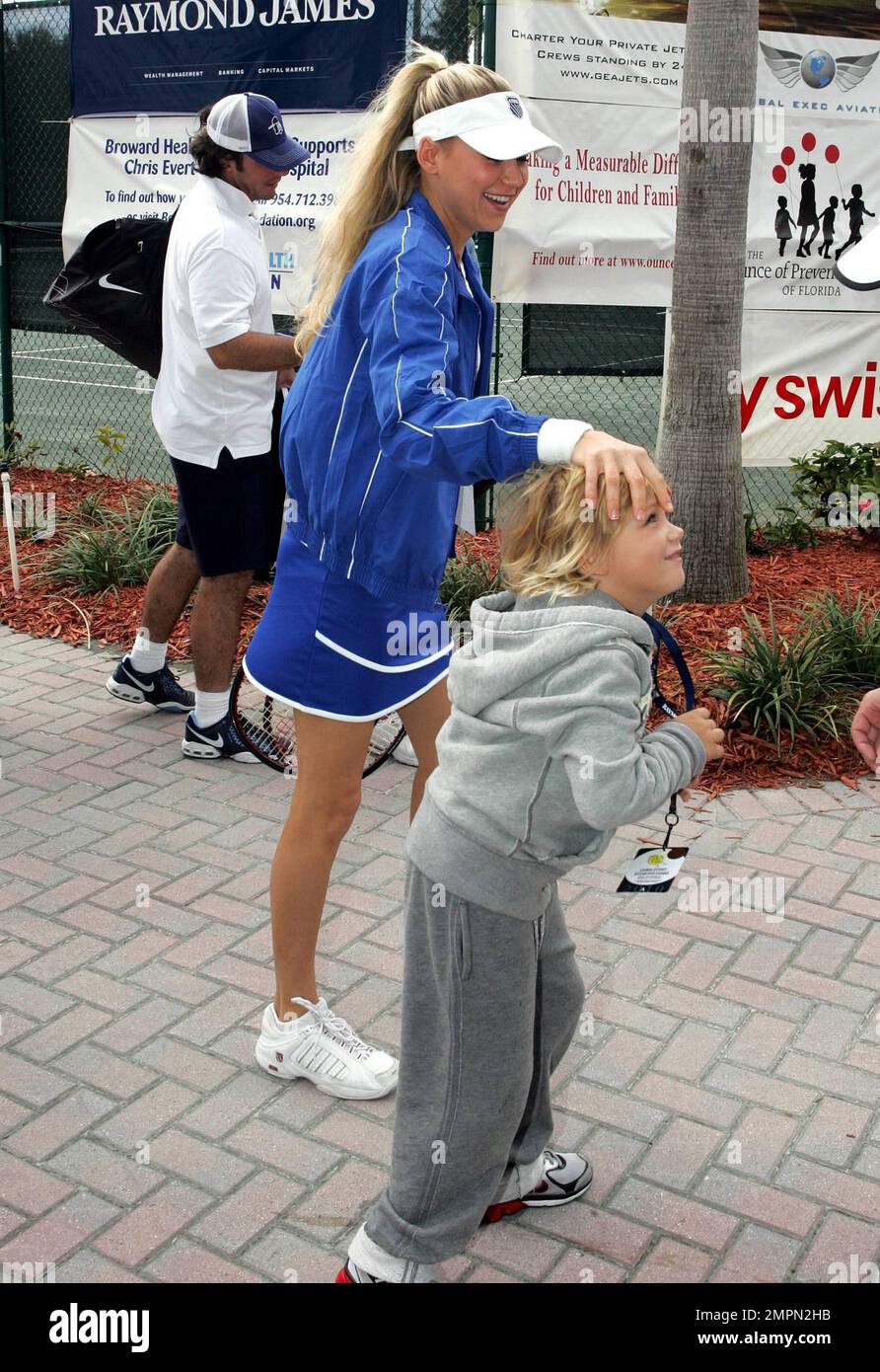 Tennis great Anna Kournikova and her brother Alan walk to the court ...