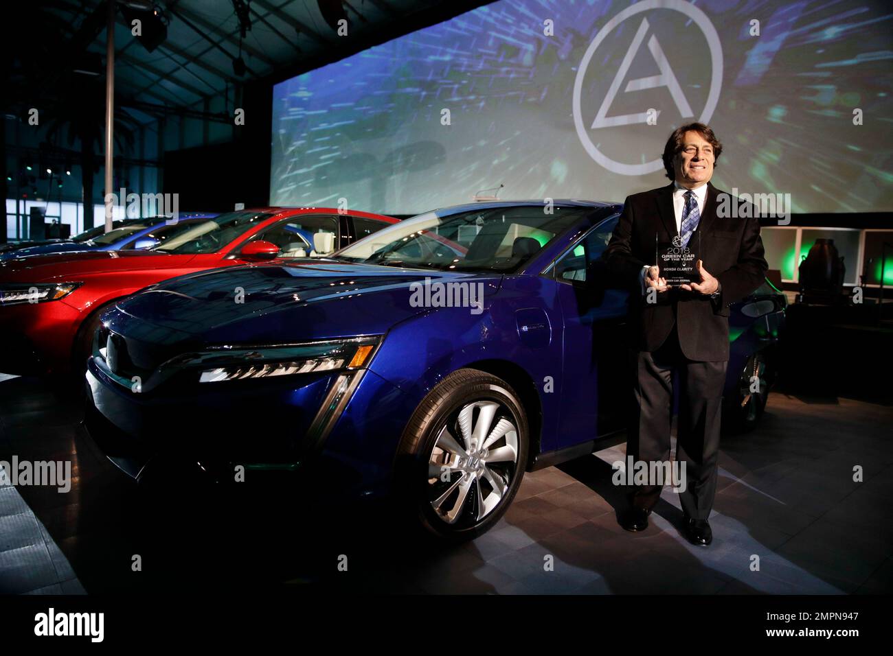Honda's Steven Center pauses for photos with the Honda Clarity after ...