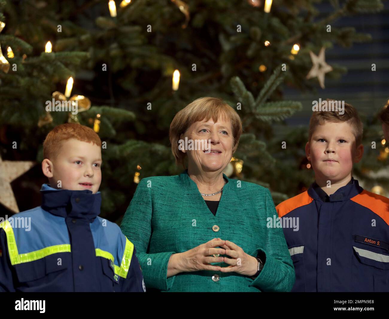 German Chancellor Angela Merkel, center, and young representatives of ...