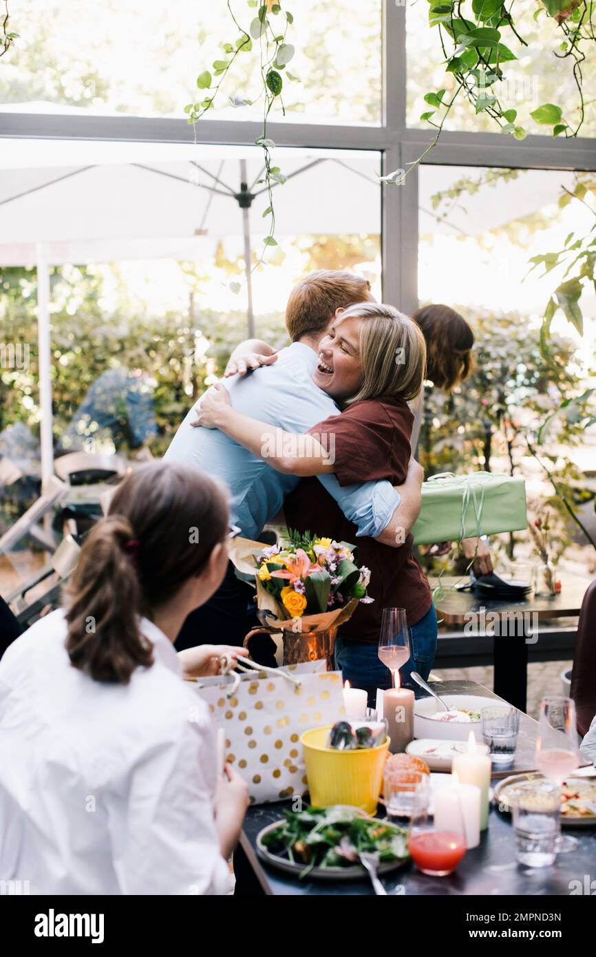 Happy parent embracing son during birthday party at restaurant Stock ...