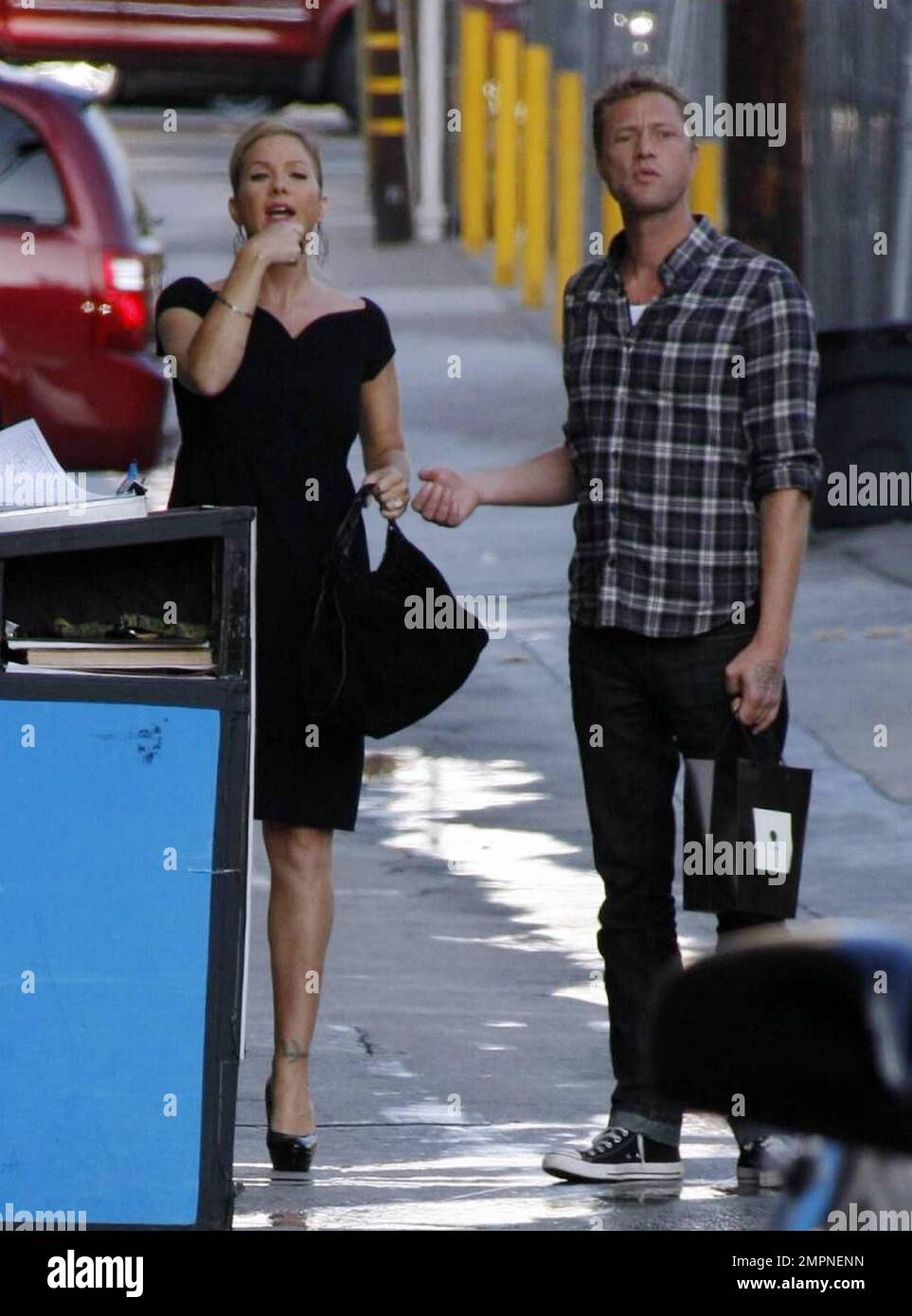 Wearing a simple black dress and sporting a short ponytail, Christina ...