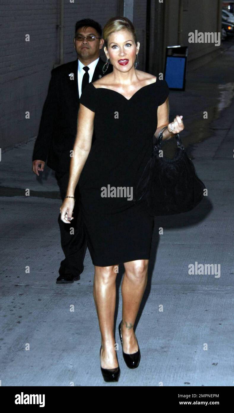 Wearing a simple black dress and sporting a short ponytail, Christina ...