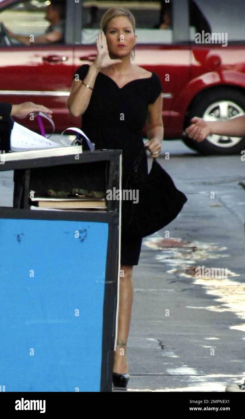 Wearing a simple black dress and sporting a short ponytail, Christina ...