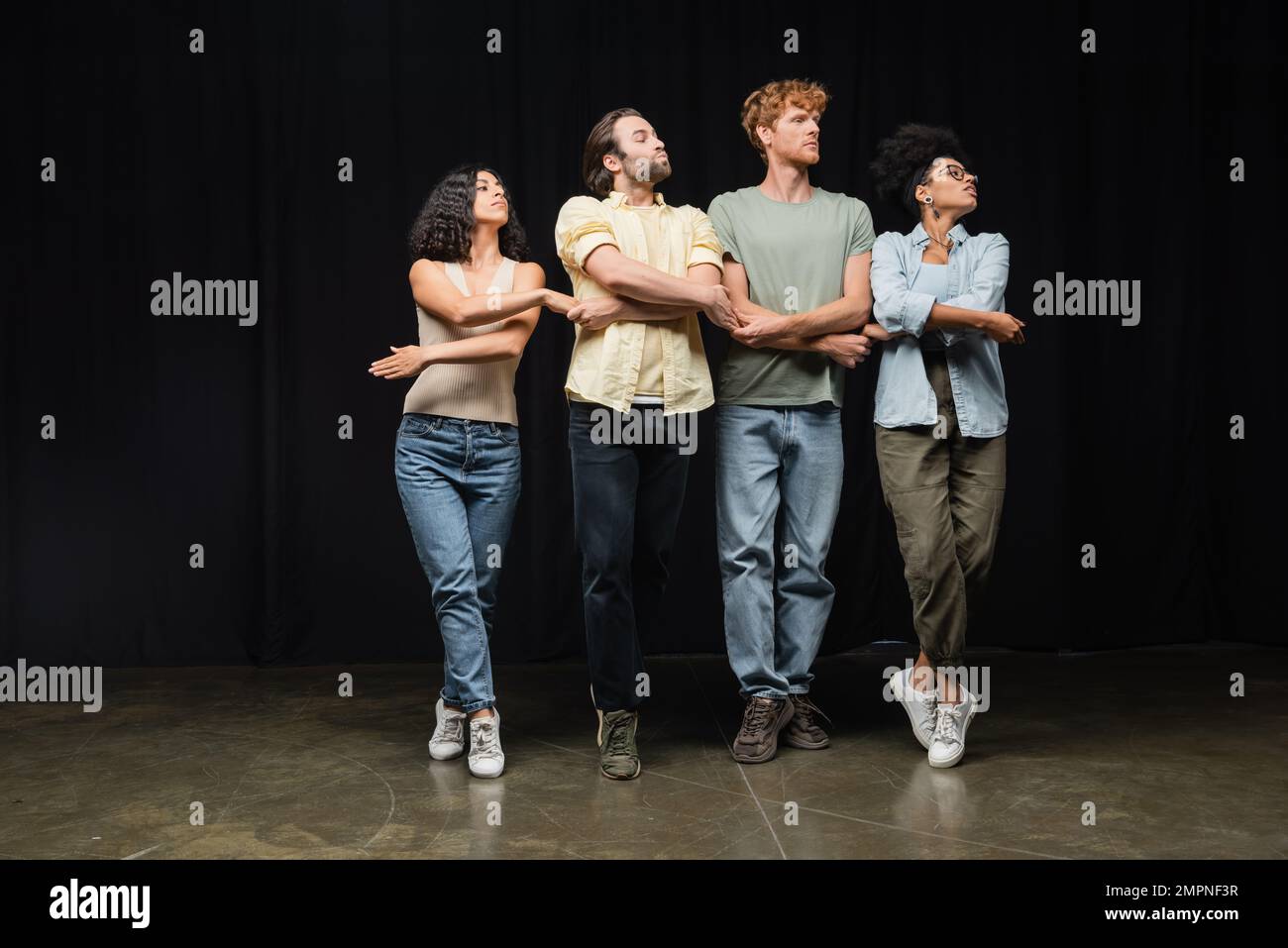 full length of young interracial actors rehearsing small swans dance in ...