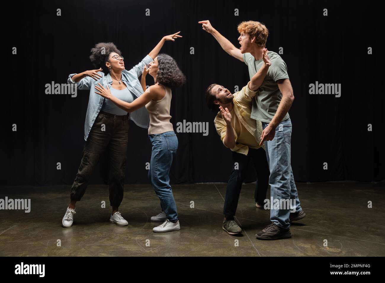 full length of young multiethnic actors posing while rehearsing in ...